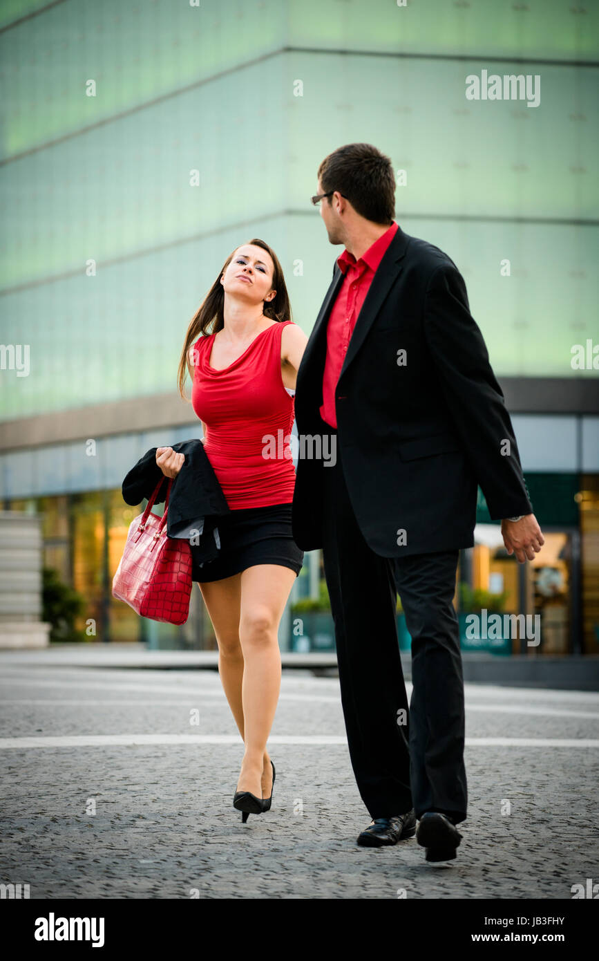 Hurry - young business man draging her girlfriend on street Stock Photo ...