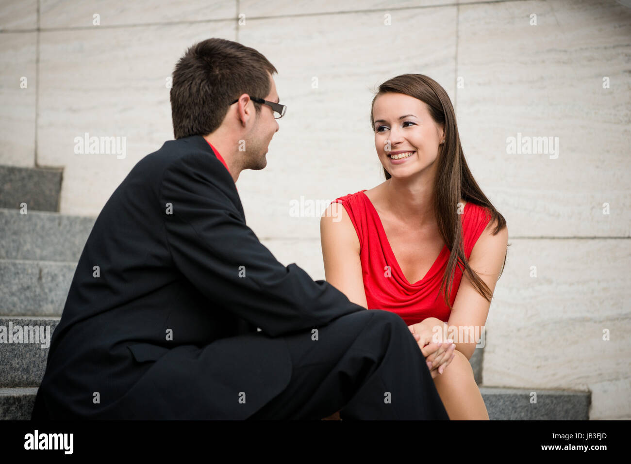 Colleagues - young business people having conversation sitting on ...