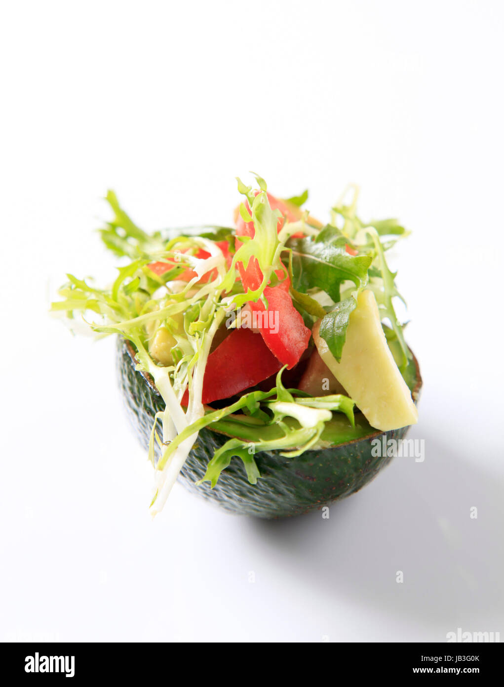 Healthy appetizer - Avocado, salad greens and tomato Stock Photo - Alamy