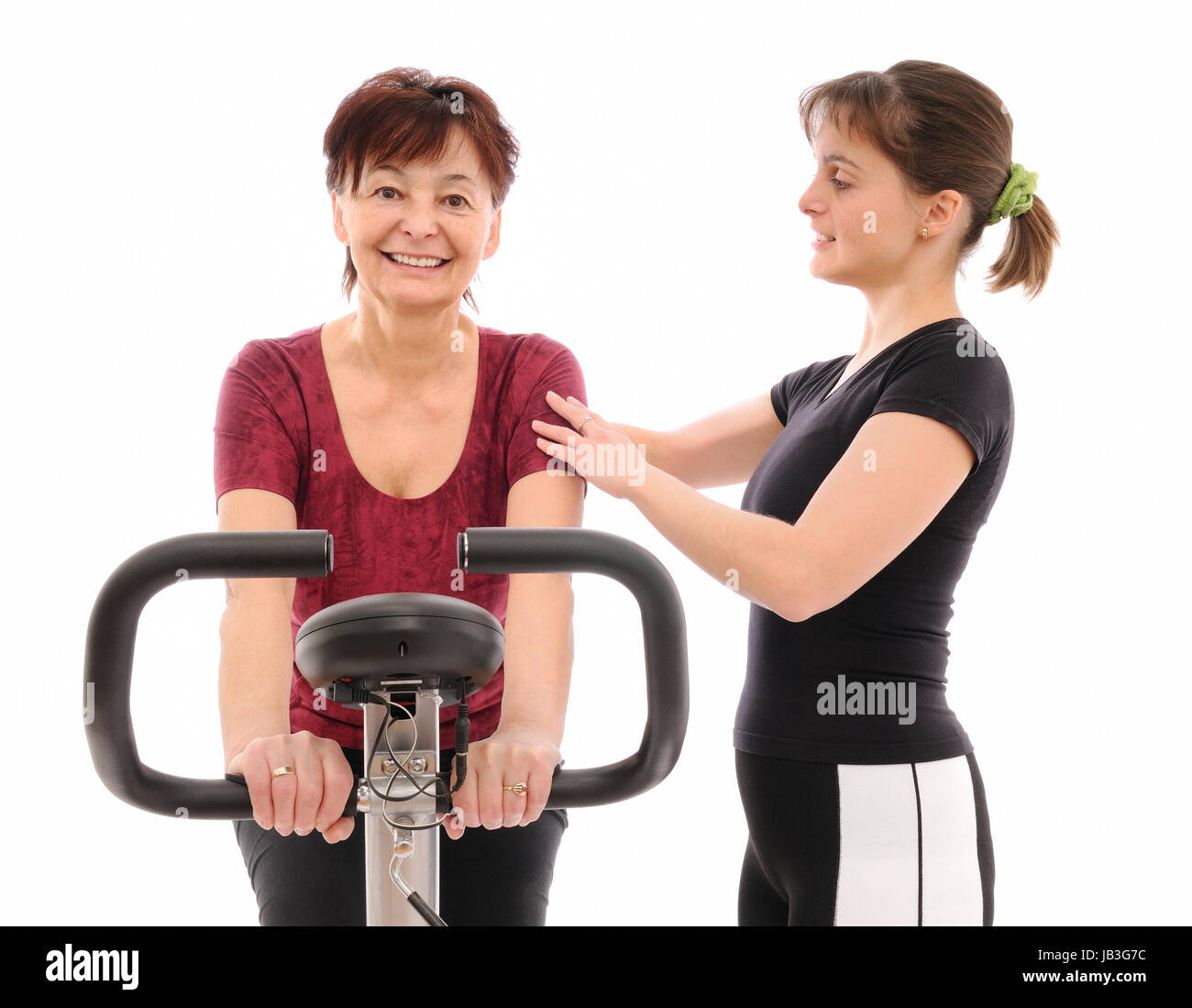 Spinning senior woman with coach Stock Photo - Alamy