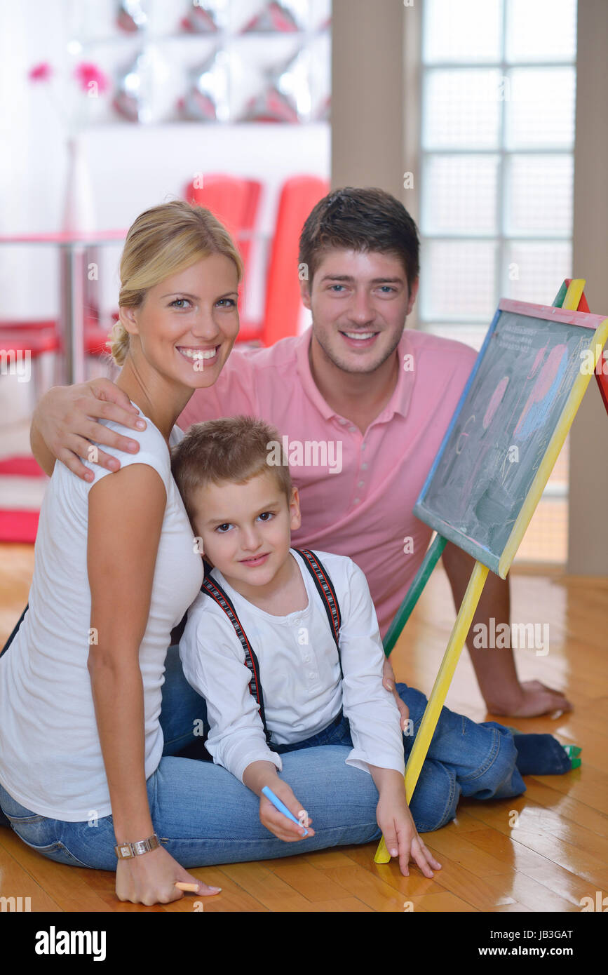 happy young family teach leassons and prepare their son for school ...