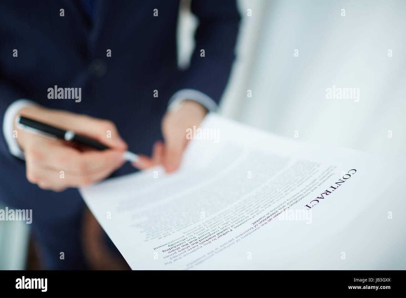 Image of contract being read and signed by businessman Stock Photo - Alamy