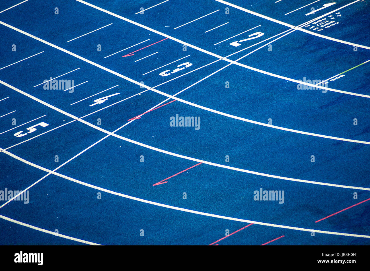 background of the start line of blue running tracks Stock Photo - Alamy