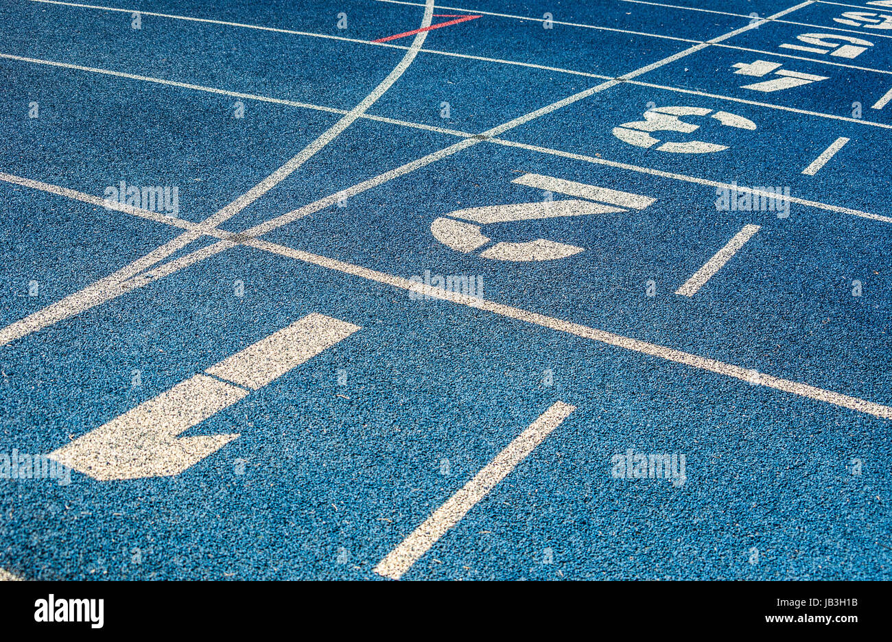 background of the start line of blue running tracks Stock Photo - Alamy