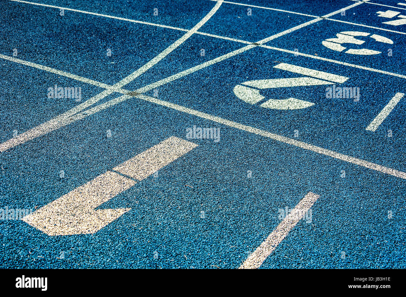 background of the start line of blue running tracks Stock Photo - Alamy