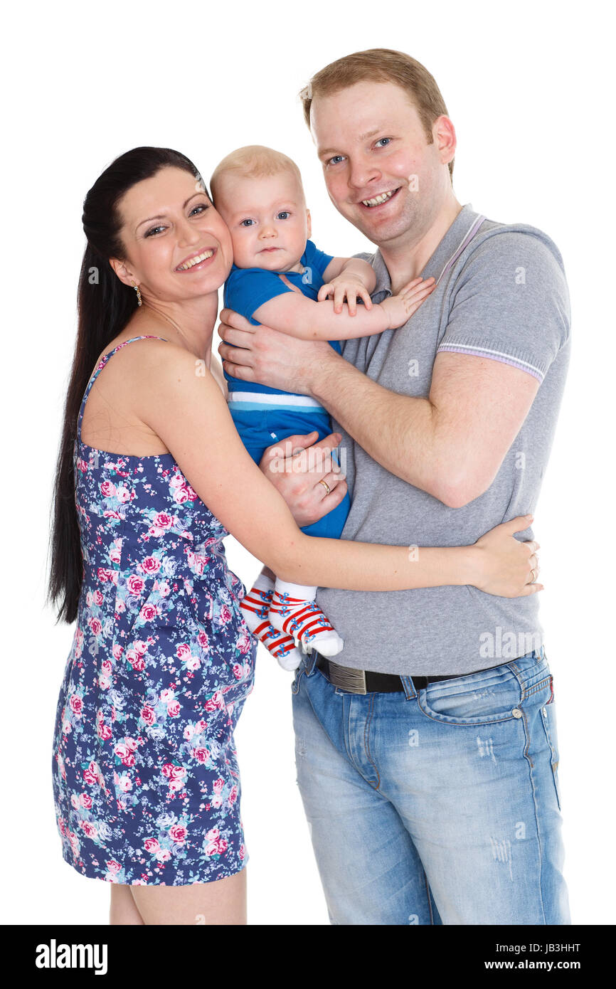 Young parents with their sweet child stand on a white background. Happy ...