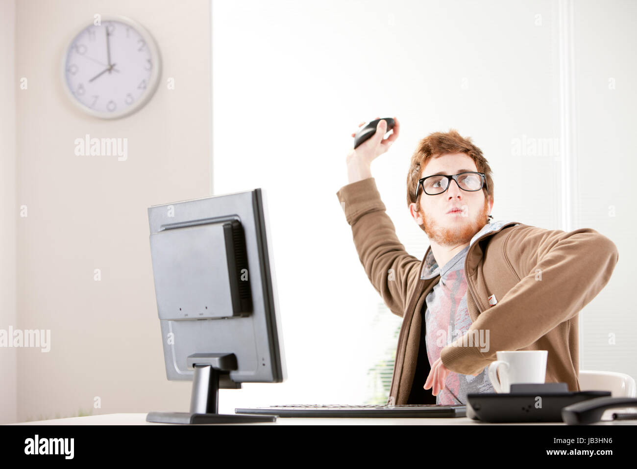 Young clerk throwing his mouse away or on the wall, who knows Stock ...