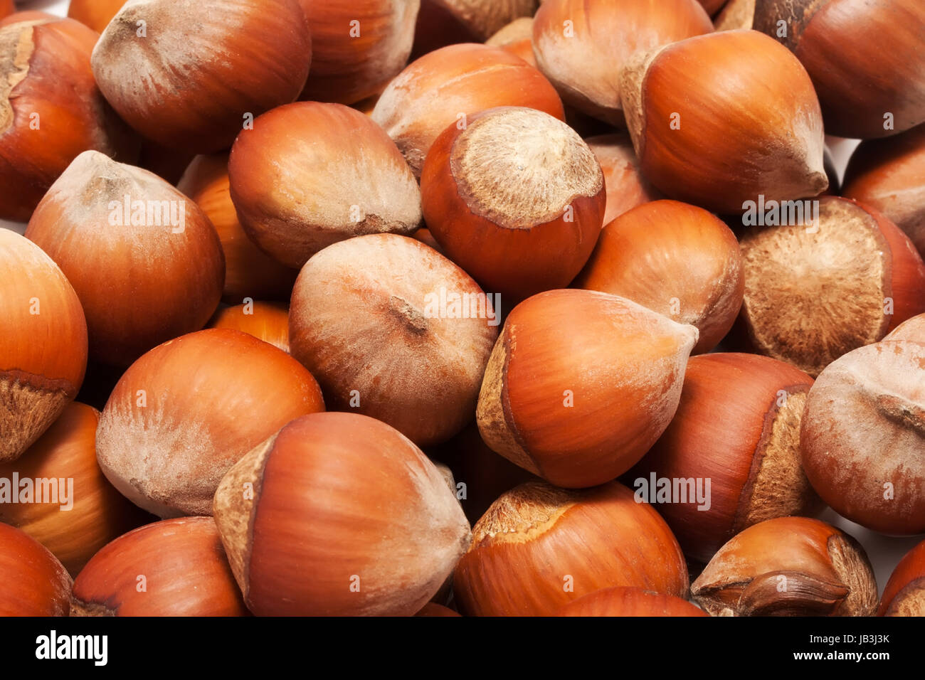 Heap of hazelnuts, filbert nuts making background Stock Photo - Alamy