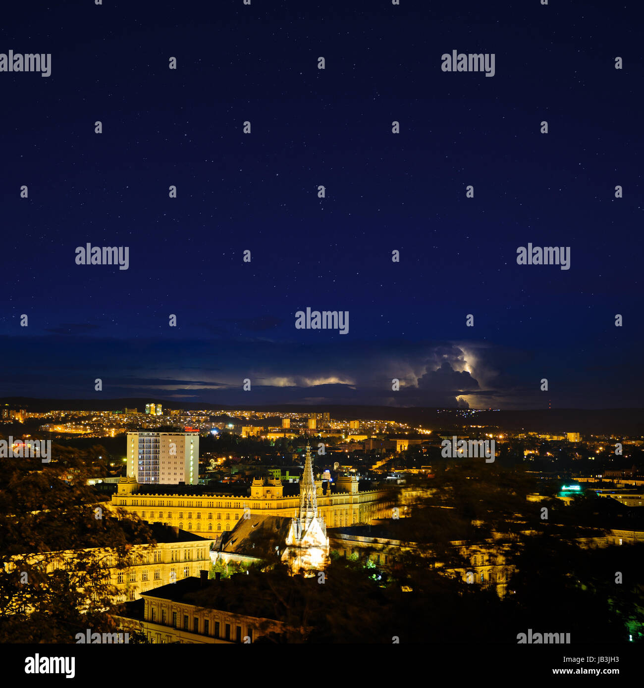 Storm leaving city scene at night with stars shining Stock Photo - Alamy