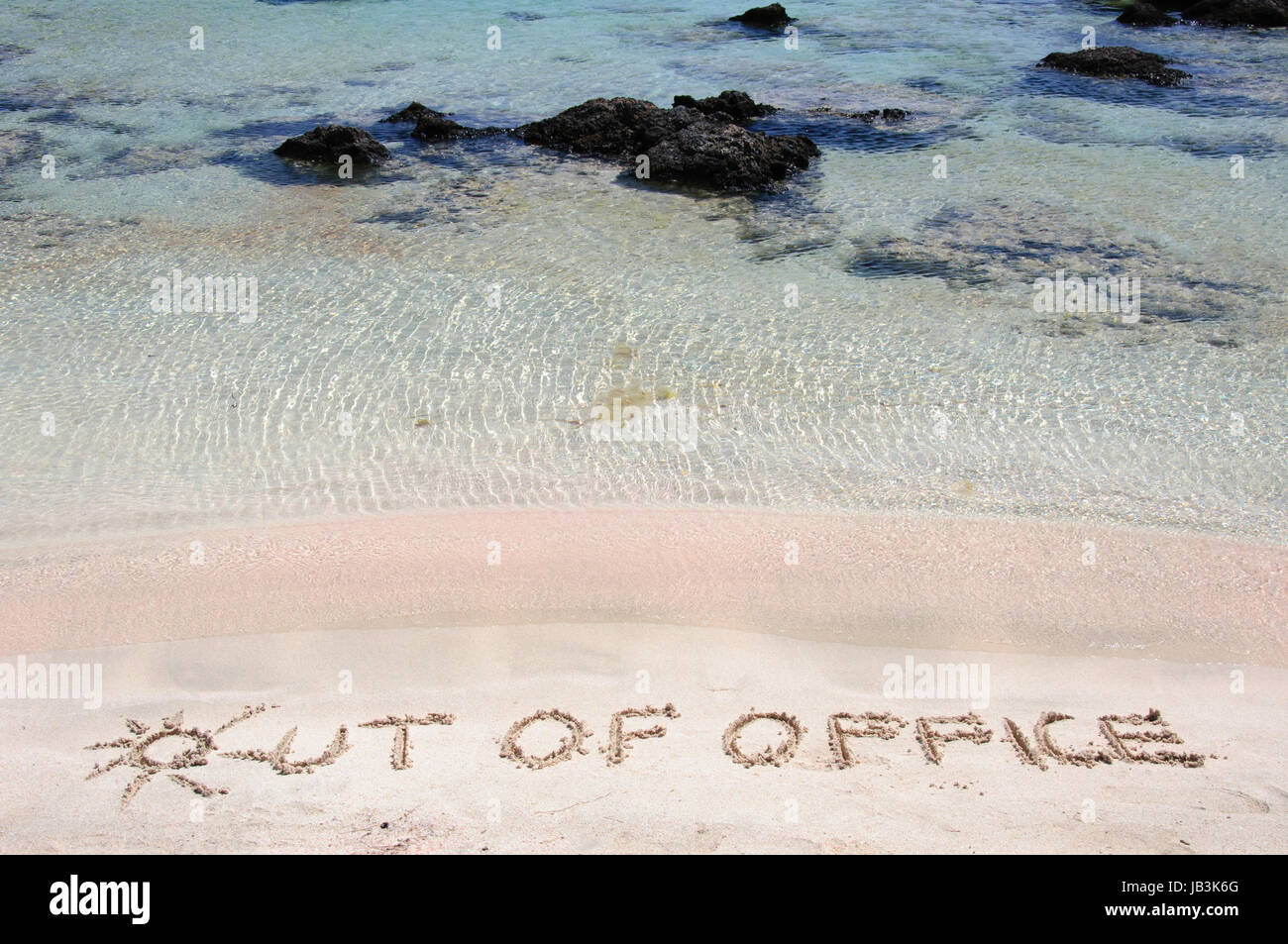 OUT OF OFFICE written on sand on a beautiful beacOUT OF OFFICE written ...