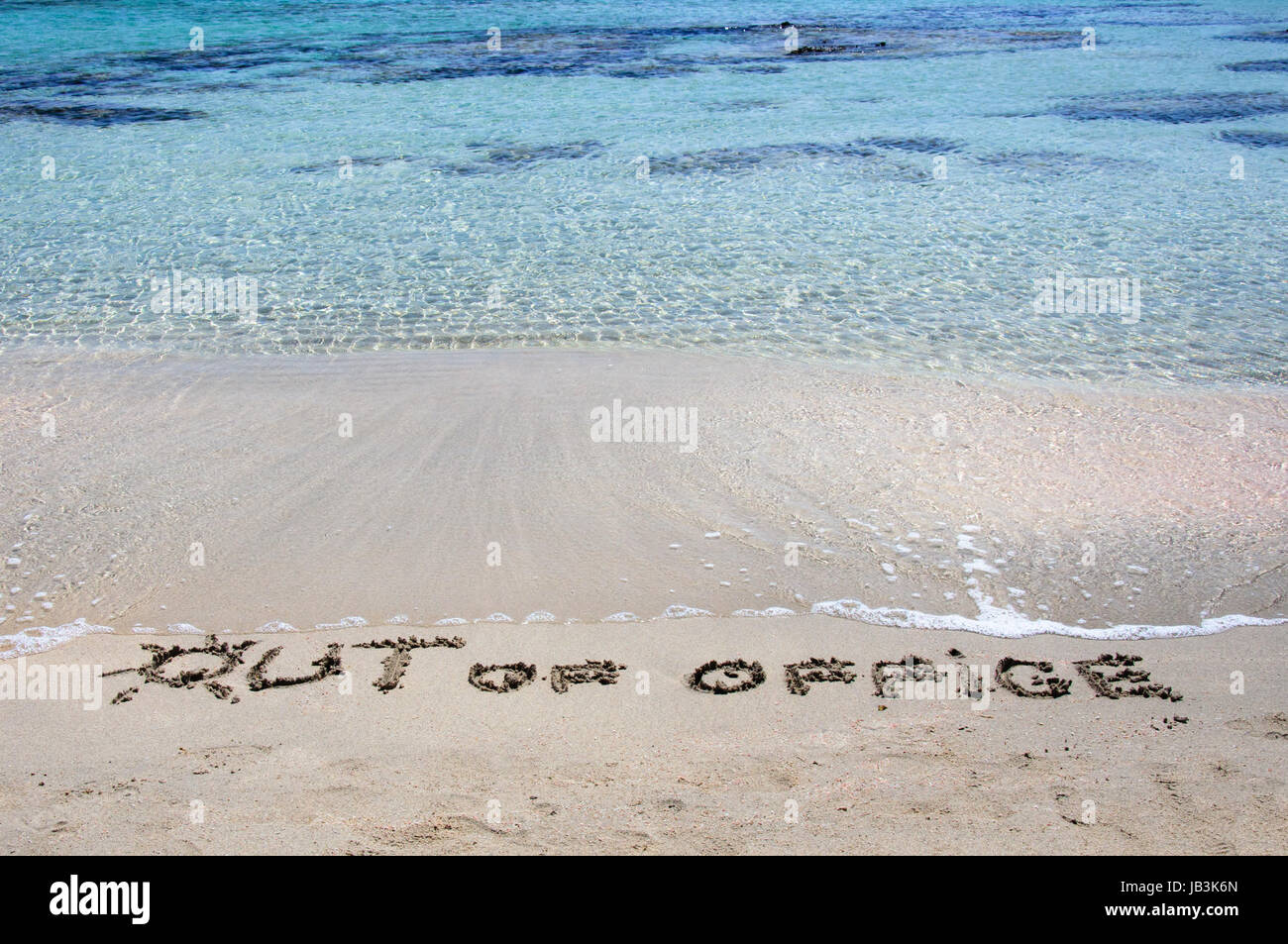 OUT OF OFFICE written on sand on a beautiful beacOUT OF OFFICE written ...