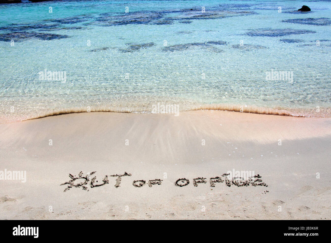 OUT OF OFFICE written on sand on a beautiful beacOUT OF OFFICE written ...