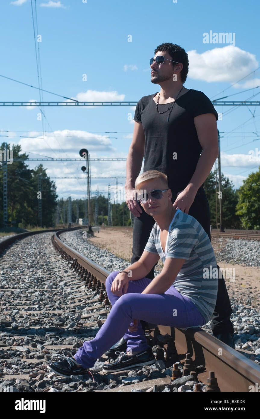 Shot of two young men on train tracks Stock Photo - Alamy