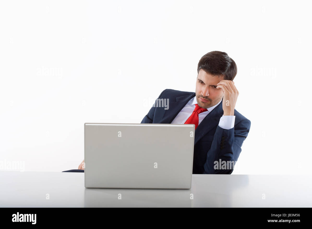 young business executive in suit behind desk with laptop Stock Photo ...