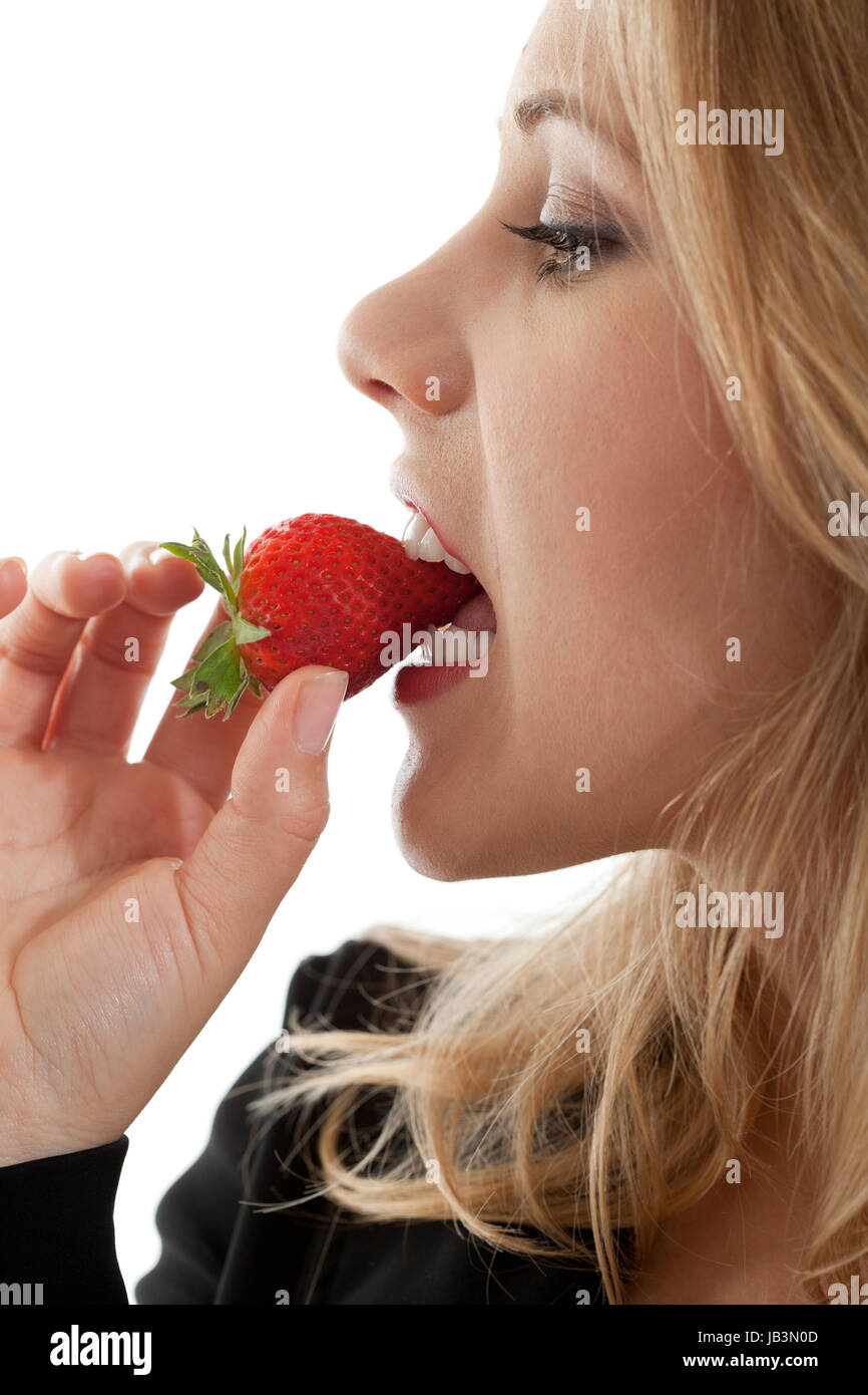 Beautiful profile of a caucasian woman biting strawberry Stock Photo ...