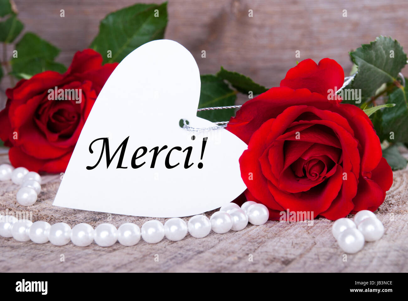 Background with Roses and Pearls and the French Word Merci which means ...