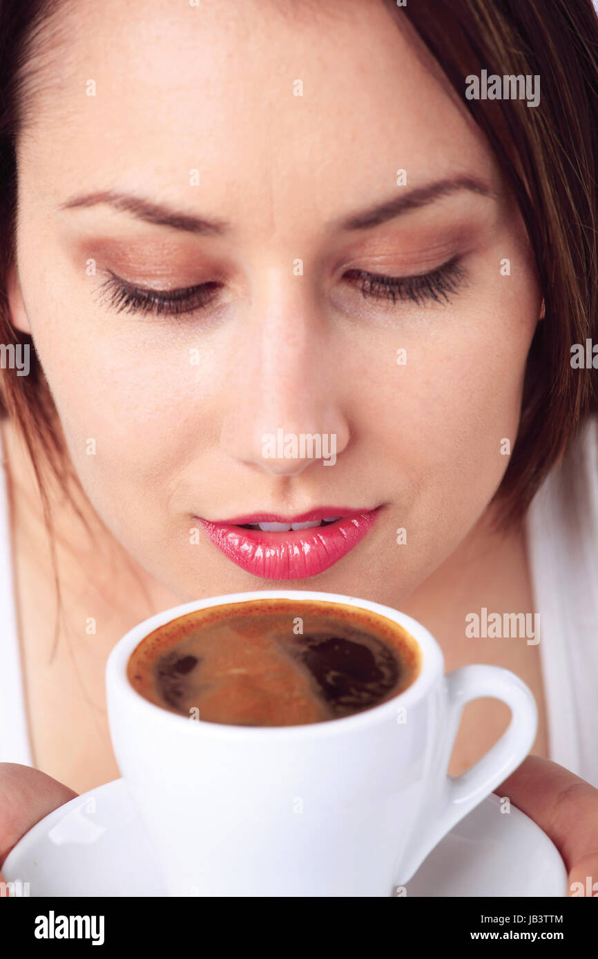 Young woman smelling a cup of coffee Stock Photo - Alamy