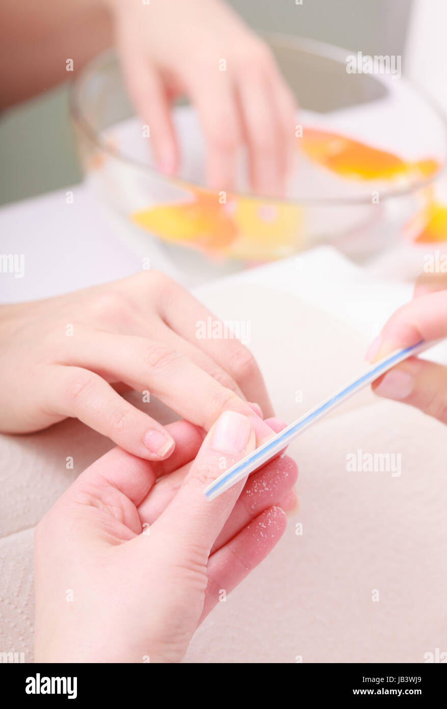 Beautician With File Filing Nails Female Client Woman Spa Beauty Salon