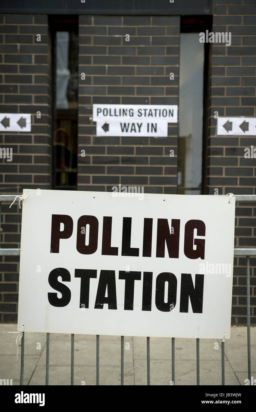British election polling station sign hanging on fence in front of ...