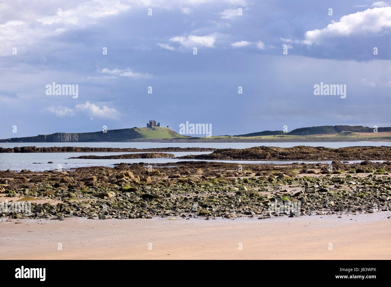 Dunstanburgh castle from beach of embleton bay Stock Photo - Alamy