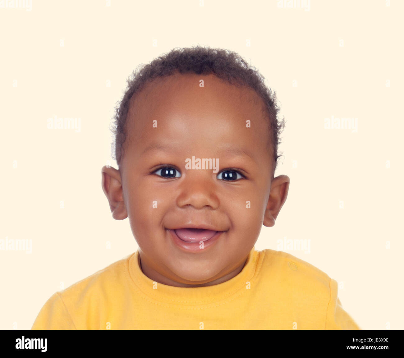 Adorable african baby with a beautiful smile on a yellow background ...