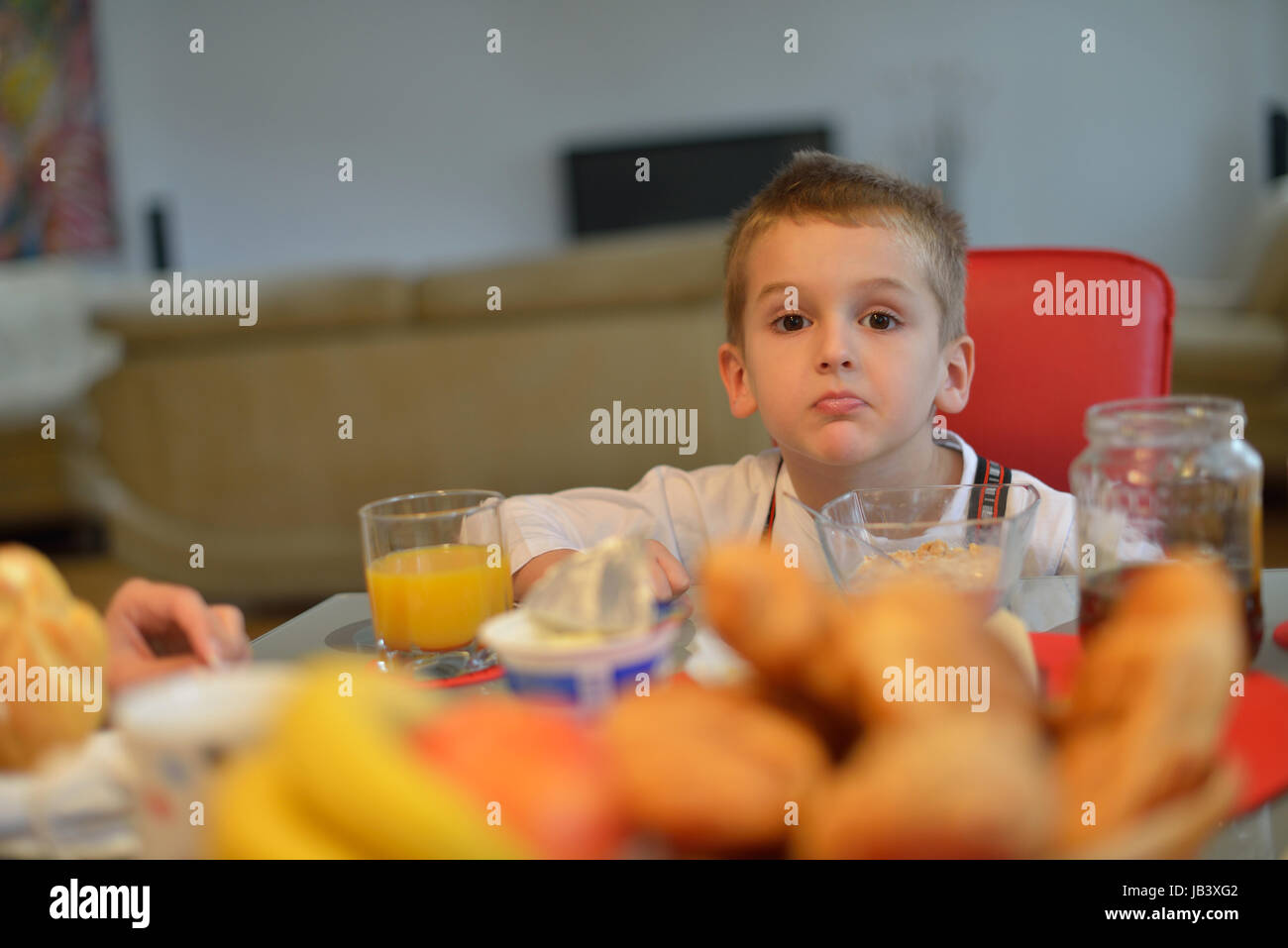 happy young family have healthy breakfast at kitchen with red details ...