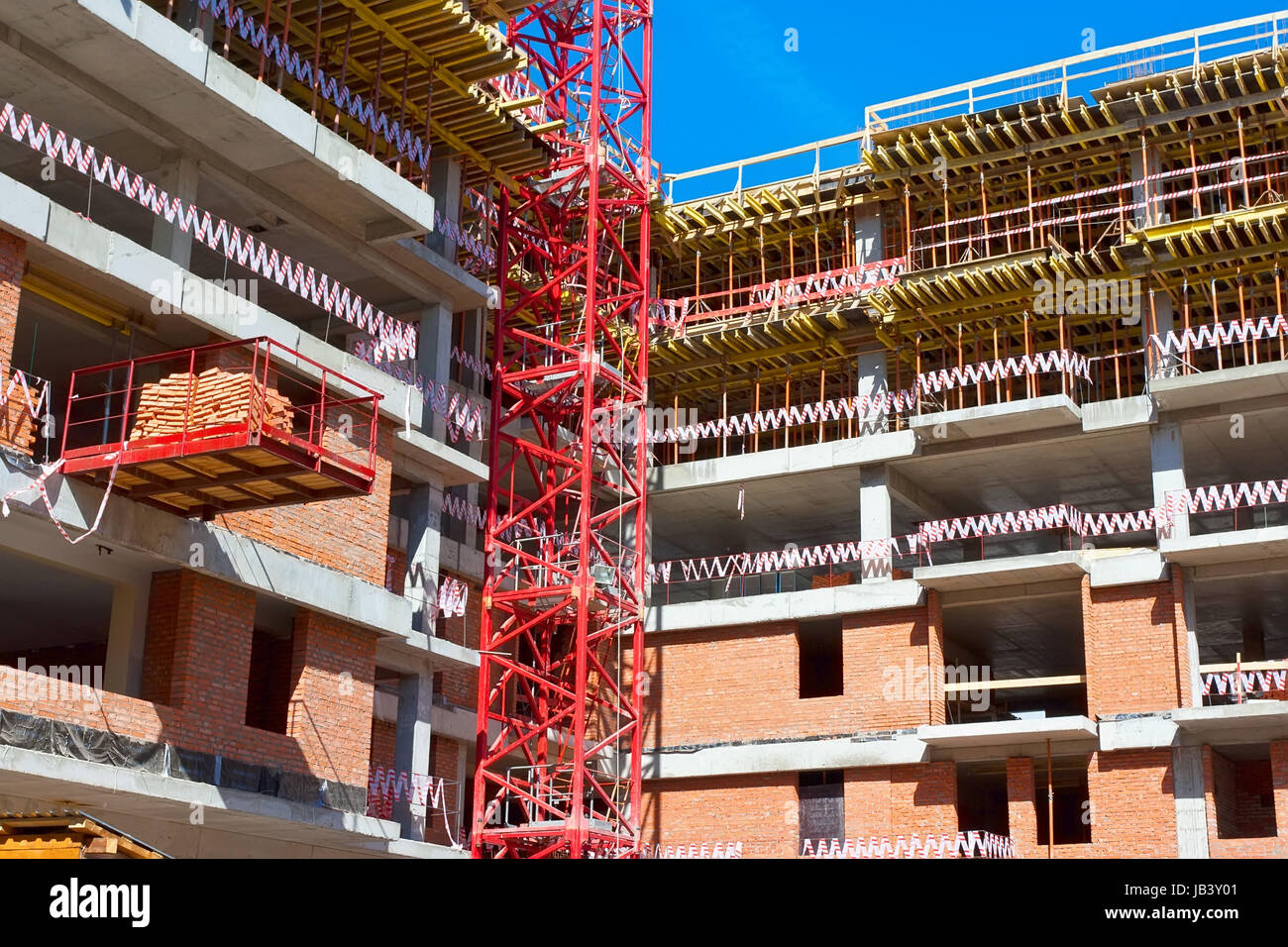 Construction of modern apartment building under blue sky Stock Photo ...