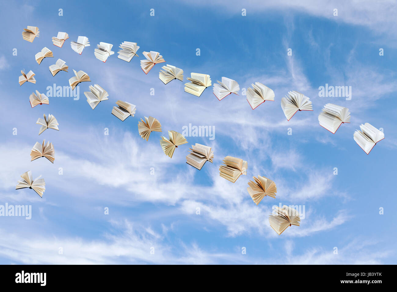 flock of flying books with blue sky with cirrus clouds background Stock ...