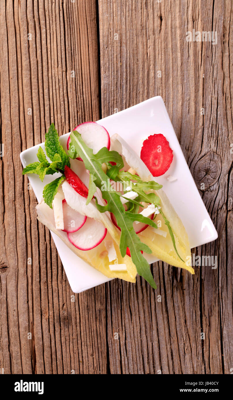 Endive and radish sprinkled with feta and rocket Stock Photo - Alamy
