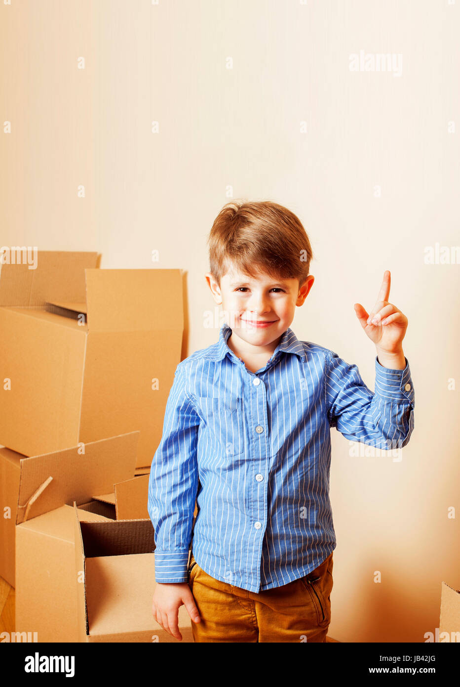 little cute boy in empty room, remoove to new house. home alone Stock ...