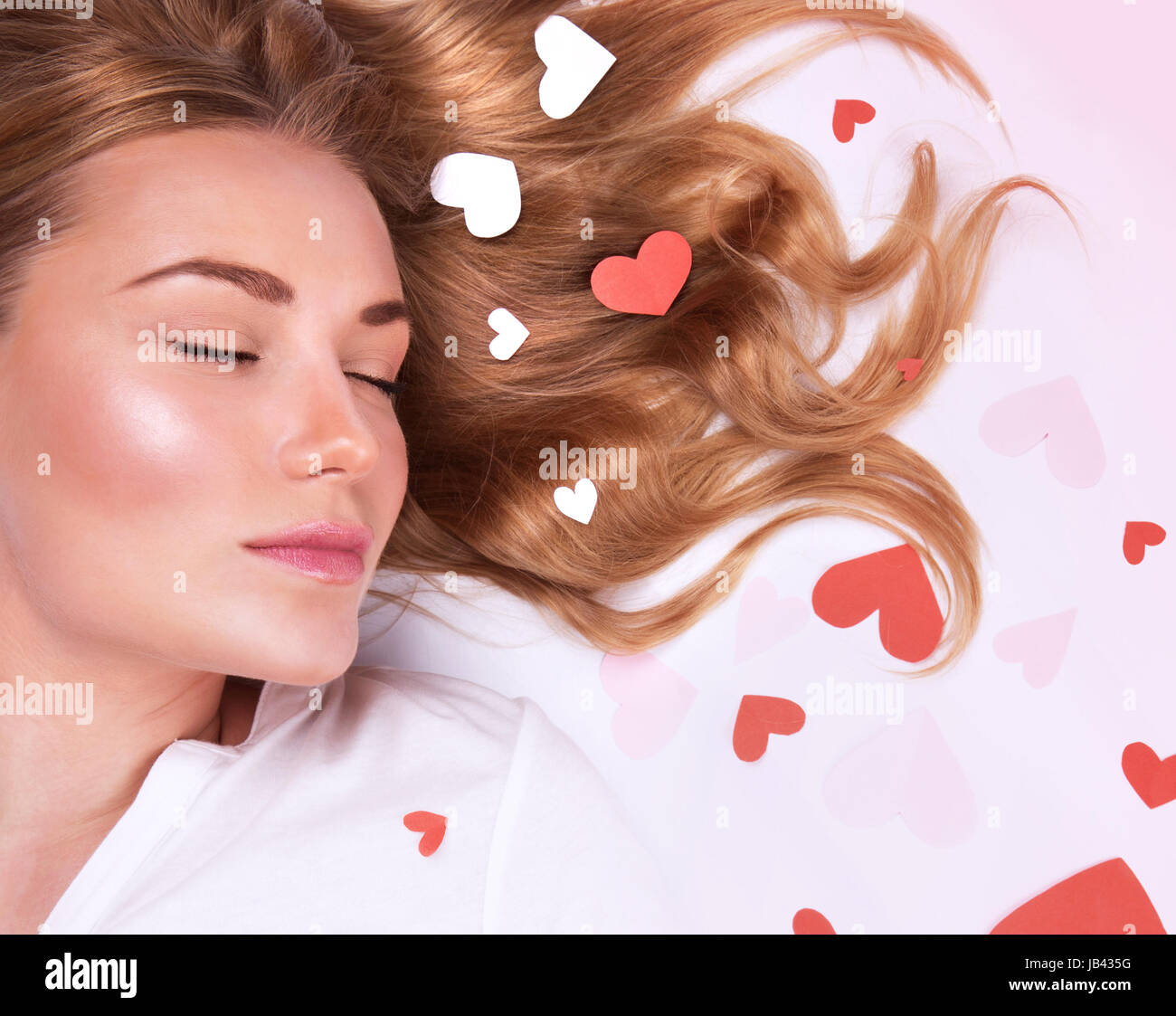 Closeup portrait of romantic fashion model lying down with closed eyes ...