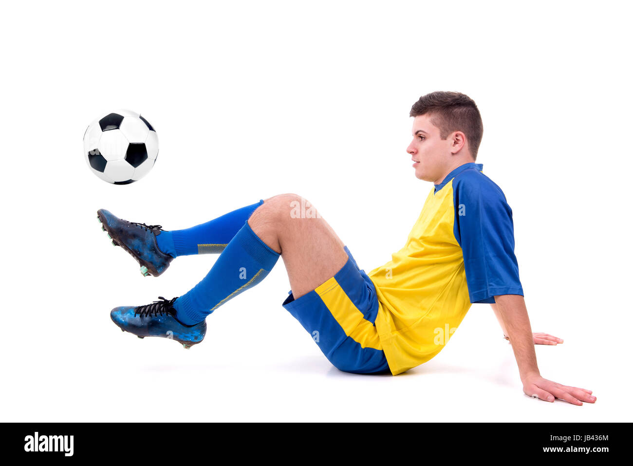 Football player with a ball isolated in white Stock Photo - Alamy