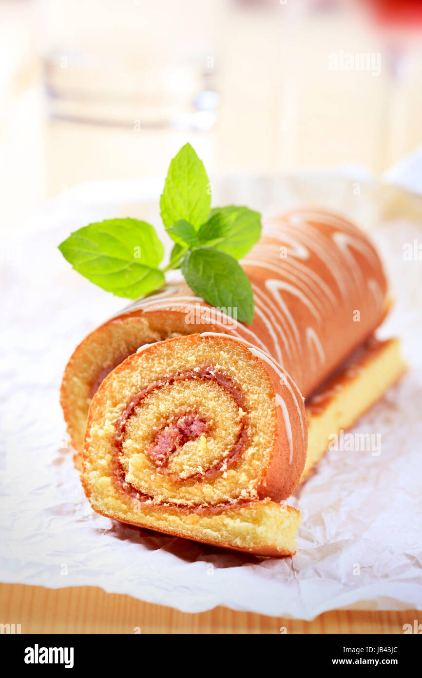 Swiss roll, slice cut off - front view Stock Photo - Alamy
