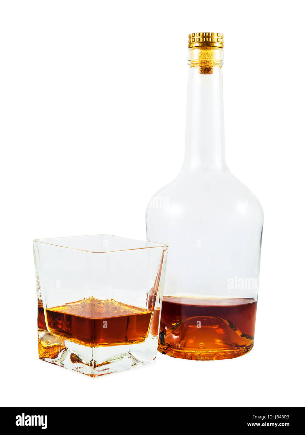 Almost empty bottle and glass of whiskey isolated on white background ...