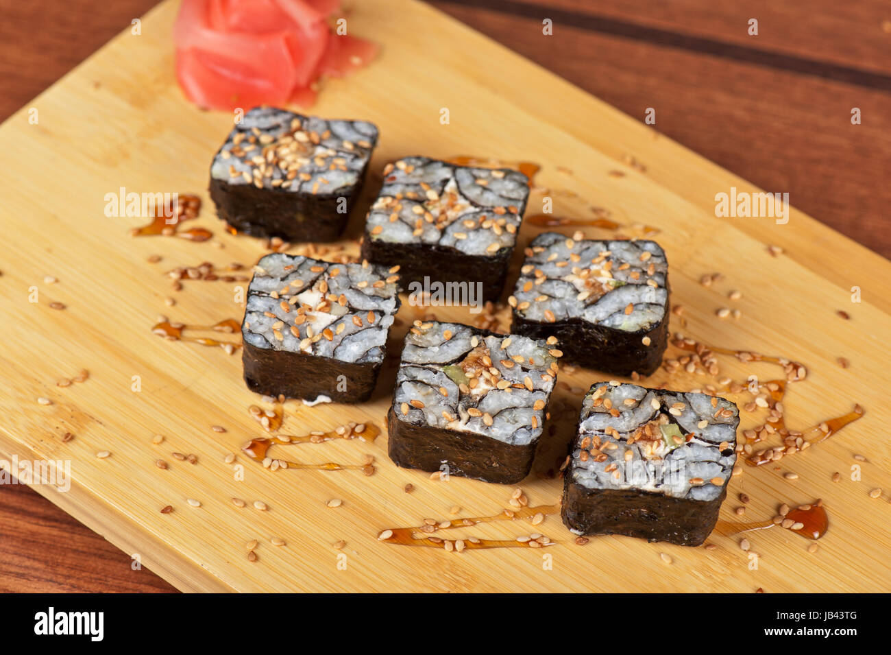 Japanese cuisine - sesame sushi rolls with syrup Stock Photo - Alamy