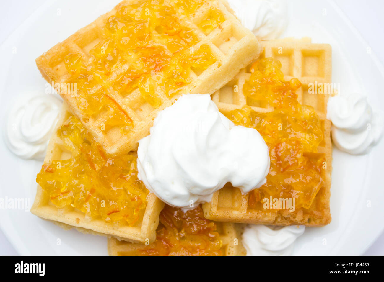 Toasted waffles with orange jam and cream on top Stock Photo - Alamy