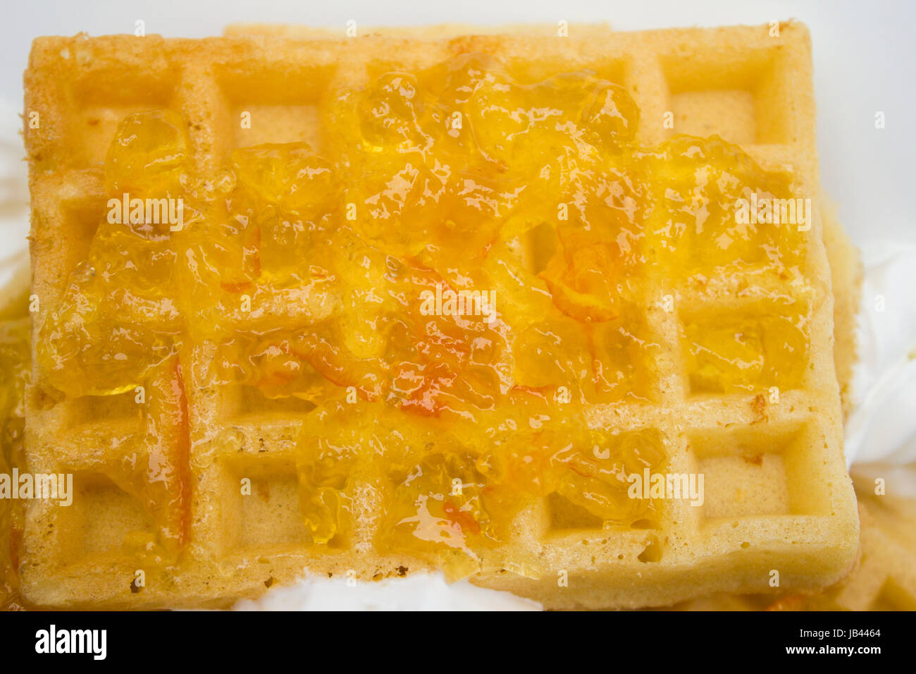 Toasted waffles with orange jam and cream on top Stock Photo - Alamy