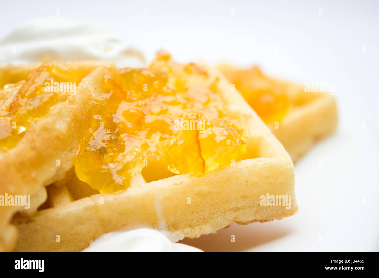 Toasted waffles with orange jam and cream on top Stock Photo - Alamy