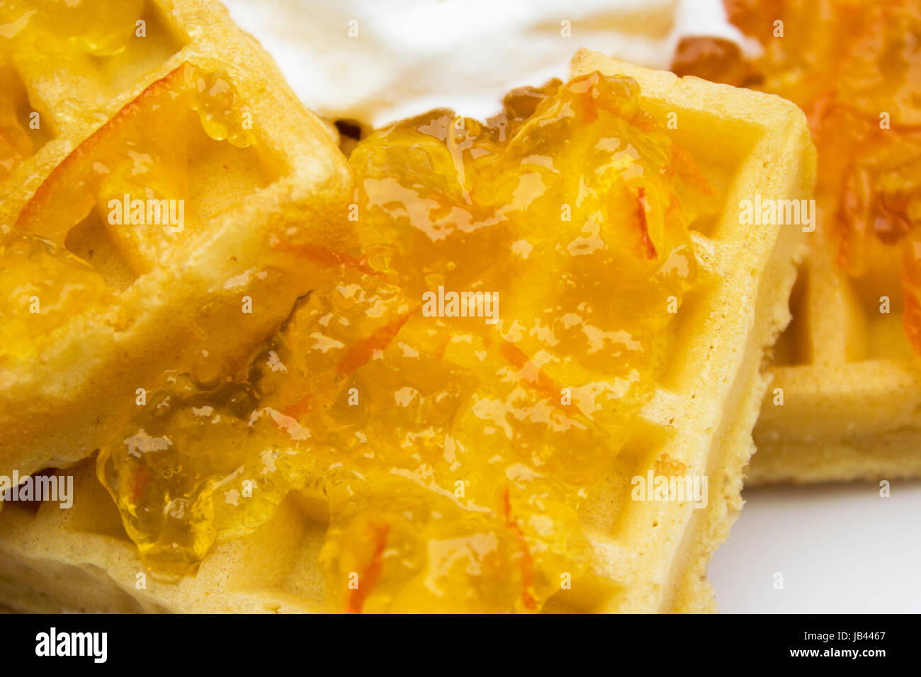 Toasted waffles with orange jam and cream on top Stock Photo - Alamy