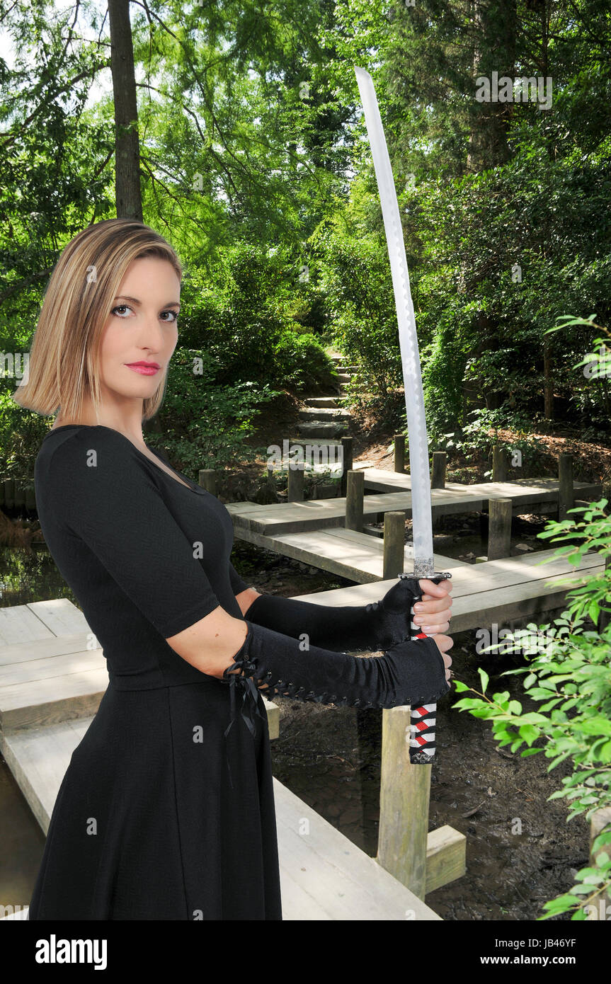 Young woman with a samurai bushido katana sword Stock Photo - Alamy