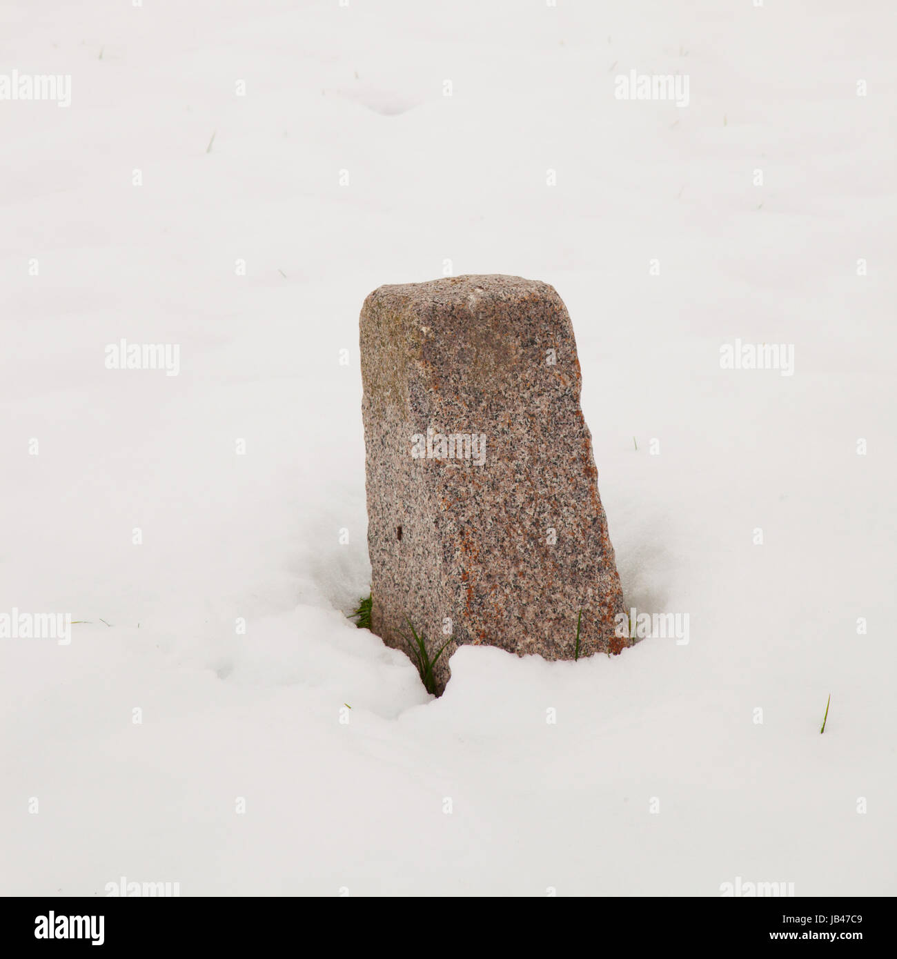A milestone in the completely white snow Stock Photo - Alamy
