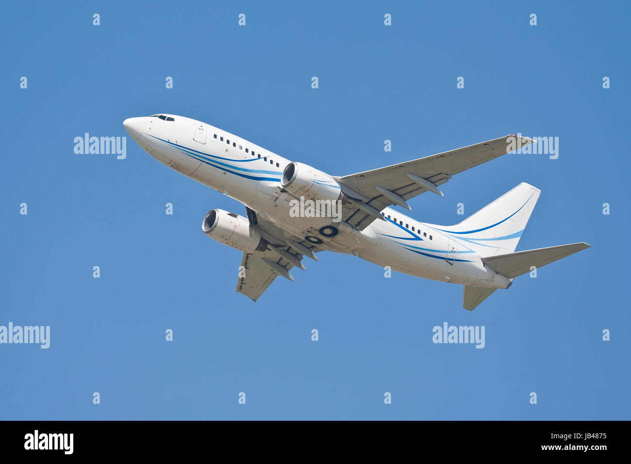 Beautiful white passenger airplane in blue sky Stock Photo - Alamy