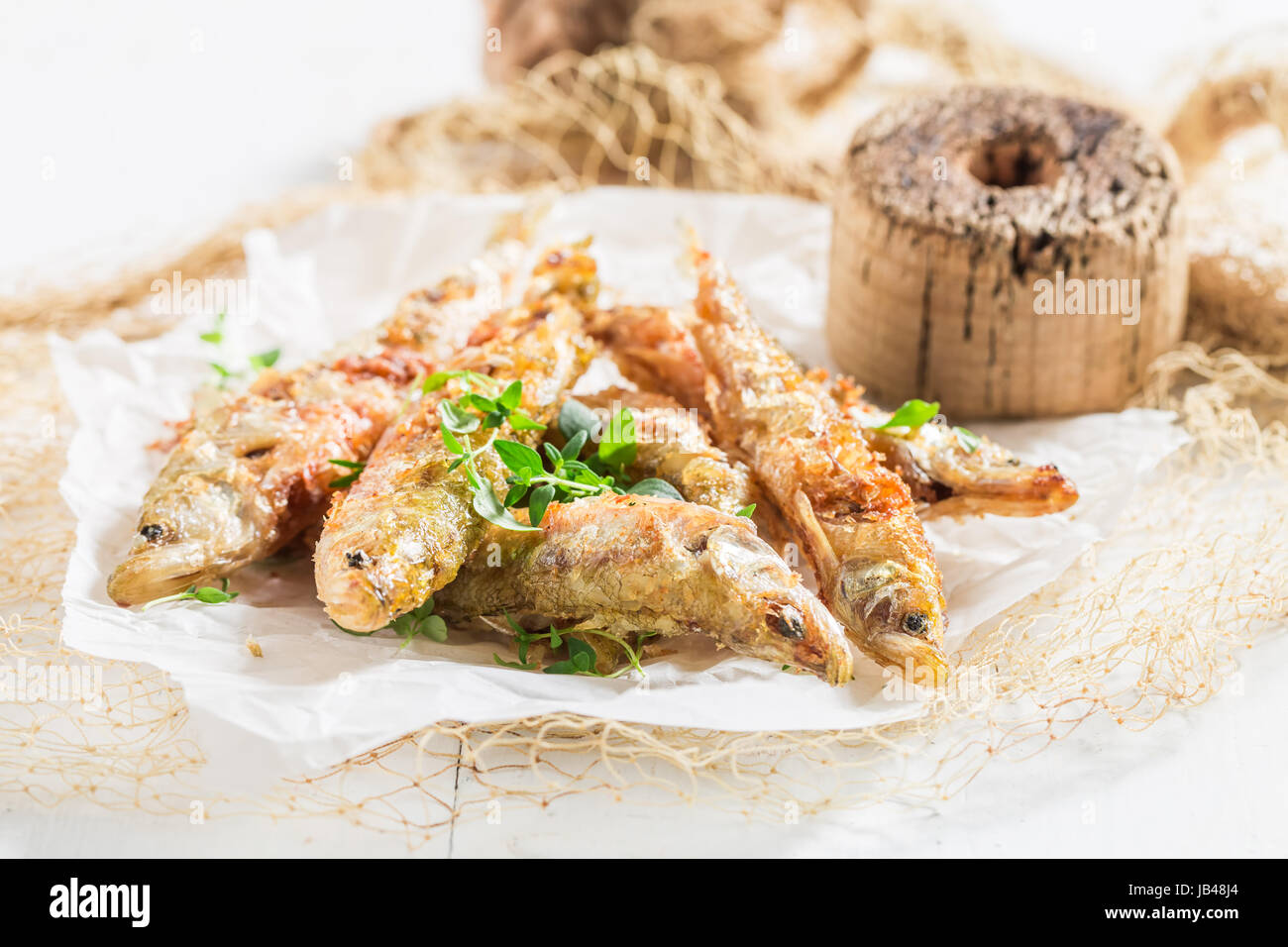 Roasted smelt fish with salt and herbs on white background Stock Photo ...