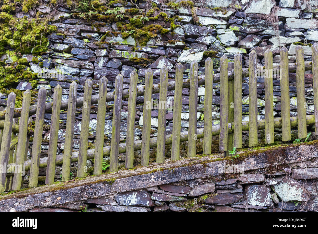 weathered wooden fence at a drystone wall Stock Photo - Alamy