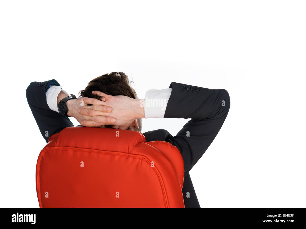View from behind of a successful relaxed businessman leaning back in ...