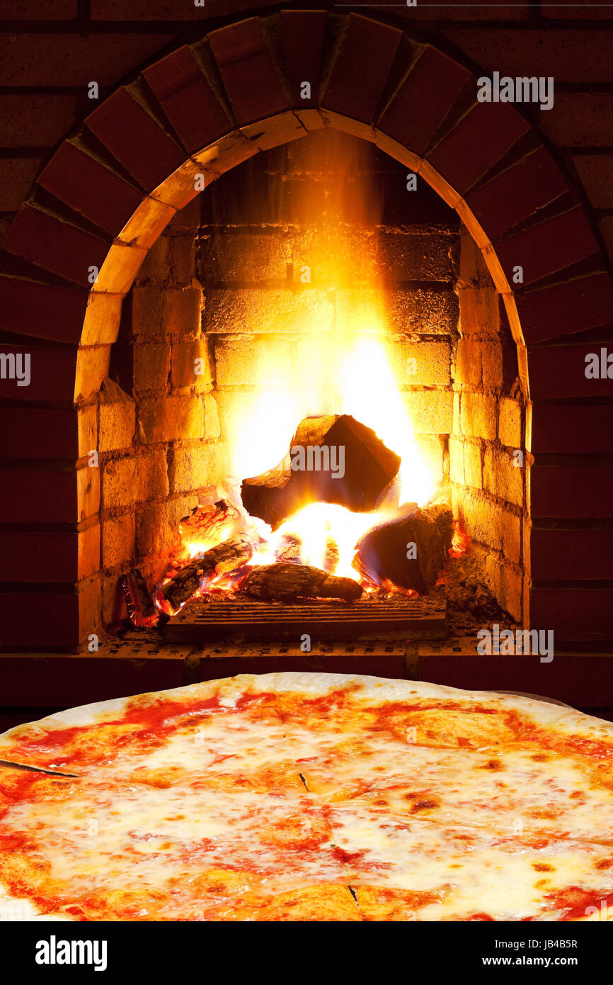 italian pizza margherita and open fire in wood burning oven Stock Photo ...