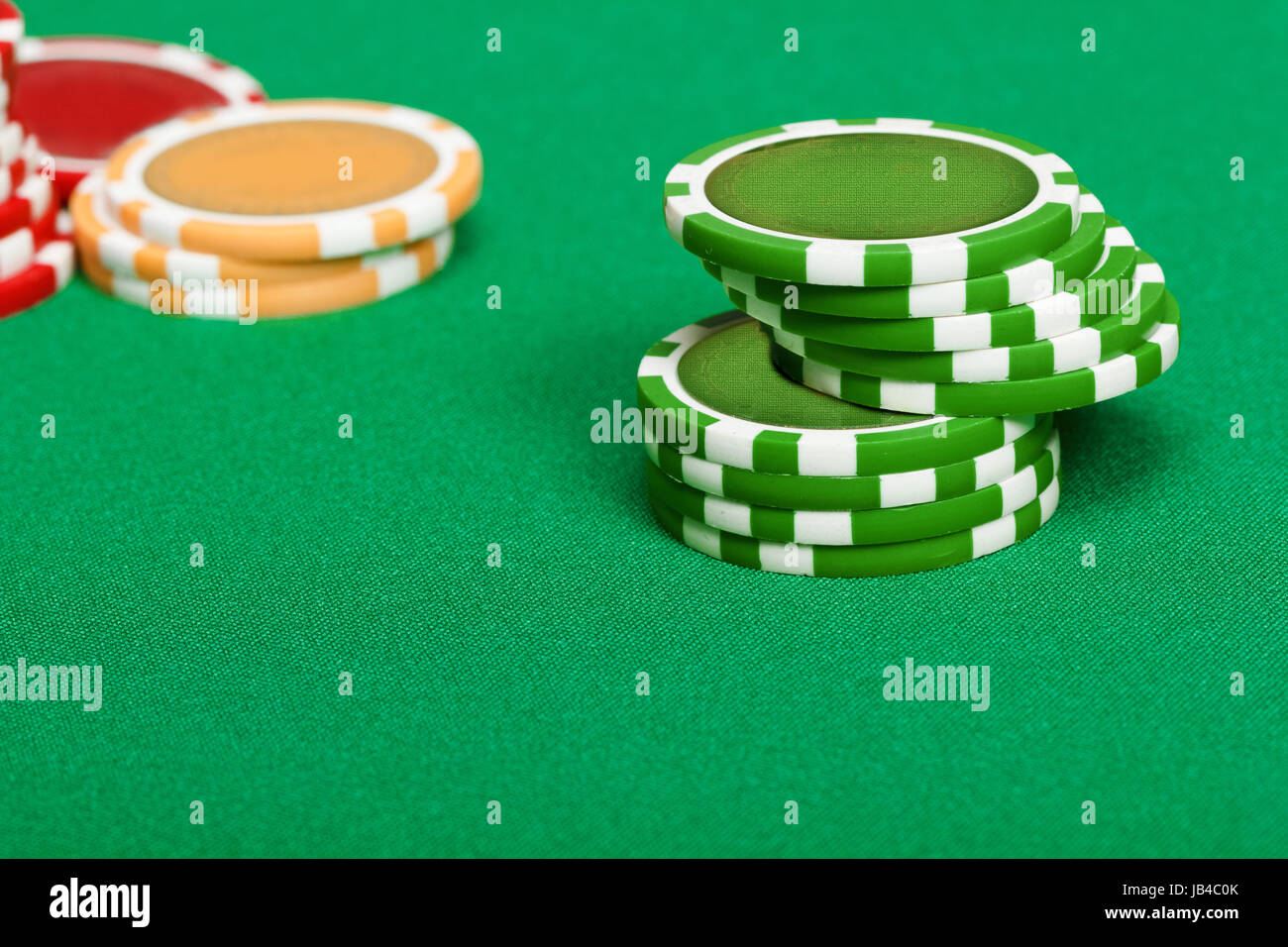 pile of playing chips on the green table Stock Photo - Alamy