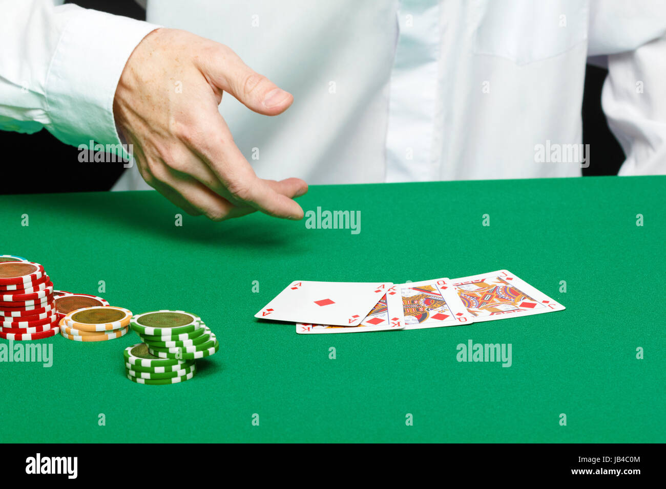 gambler. Male hand with cards and chips on green table Stock Photo - Alamy