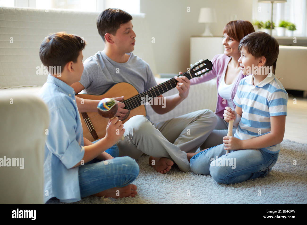 Portrait of handsome siblings and their father playing musical ...