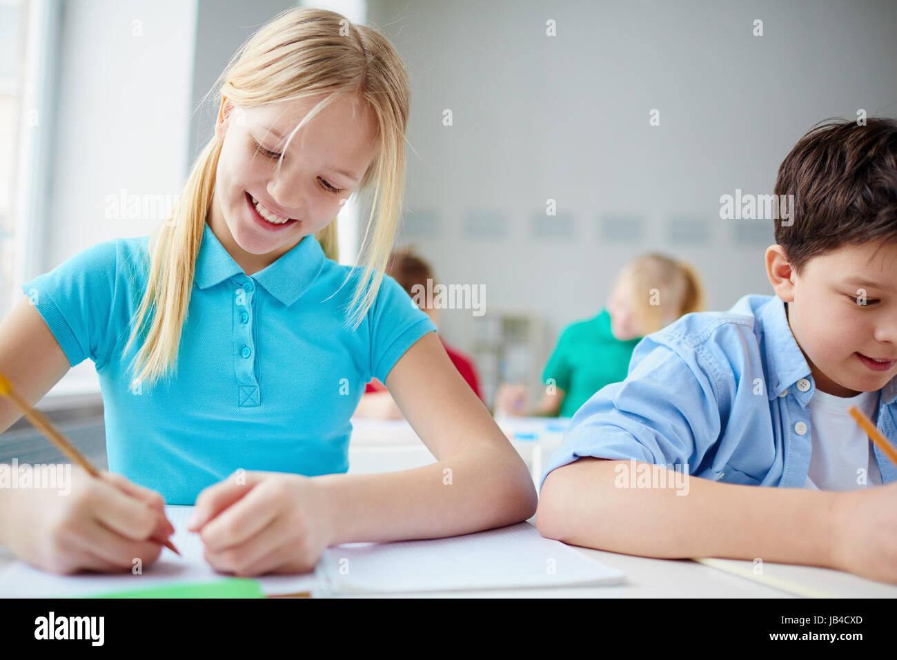 Portrait of diligent pupils drawing at lesson Stock Photo - Alamy